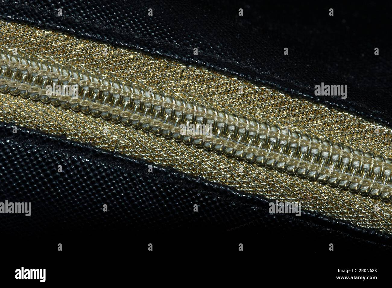 Golden zipped on a black background , Golden plastic zipper Stock Photo ...