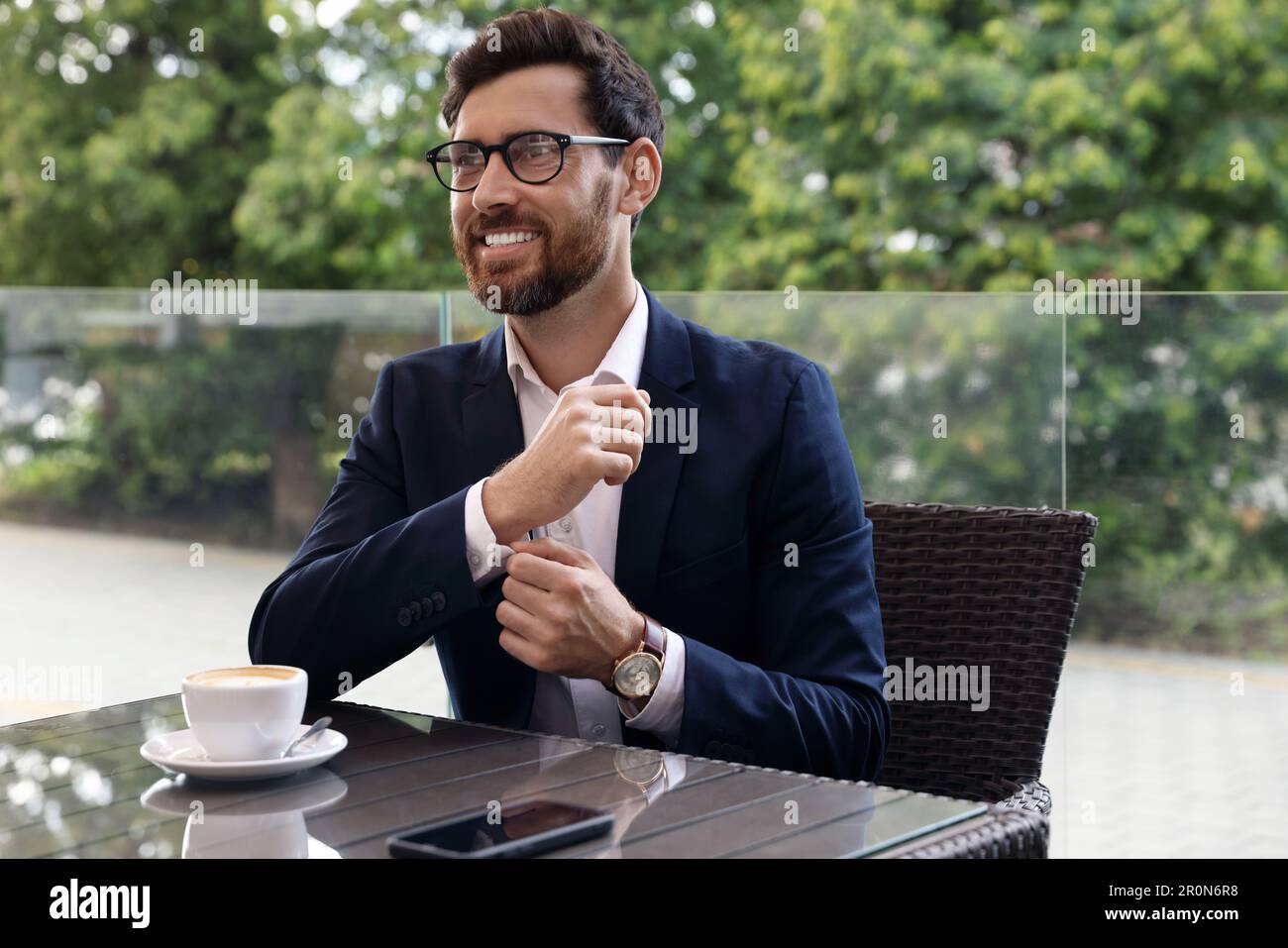 Man adjusting cufflinks hi-res stock photography and images - Alamy