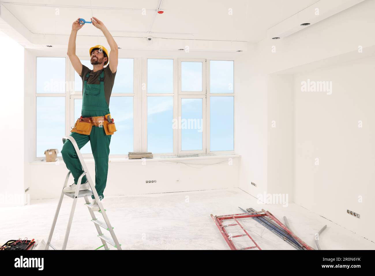 Electrician fixing wires with insulating tape indoors Stock Photo - Alamy