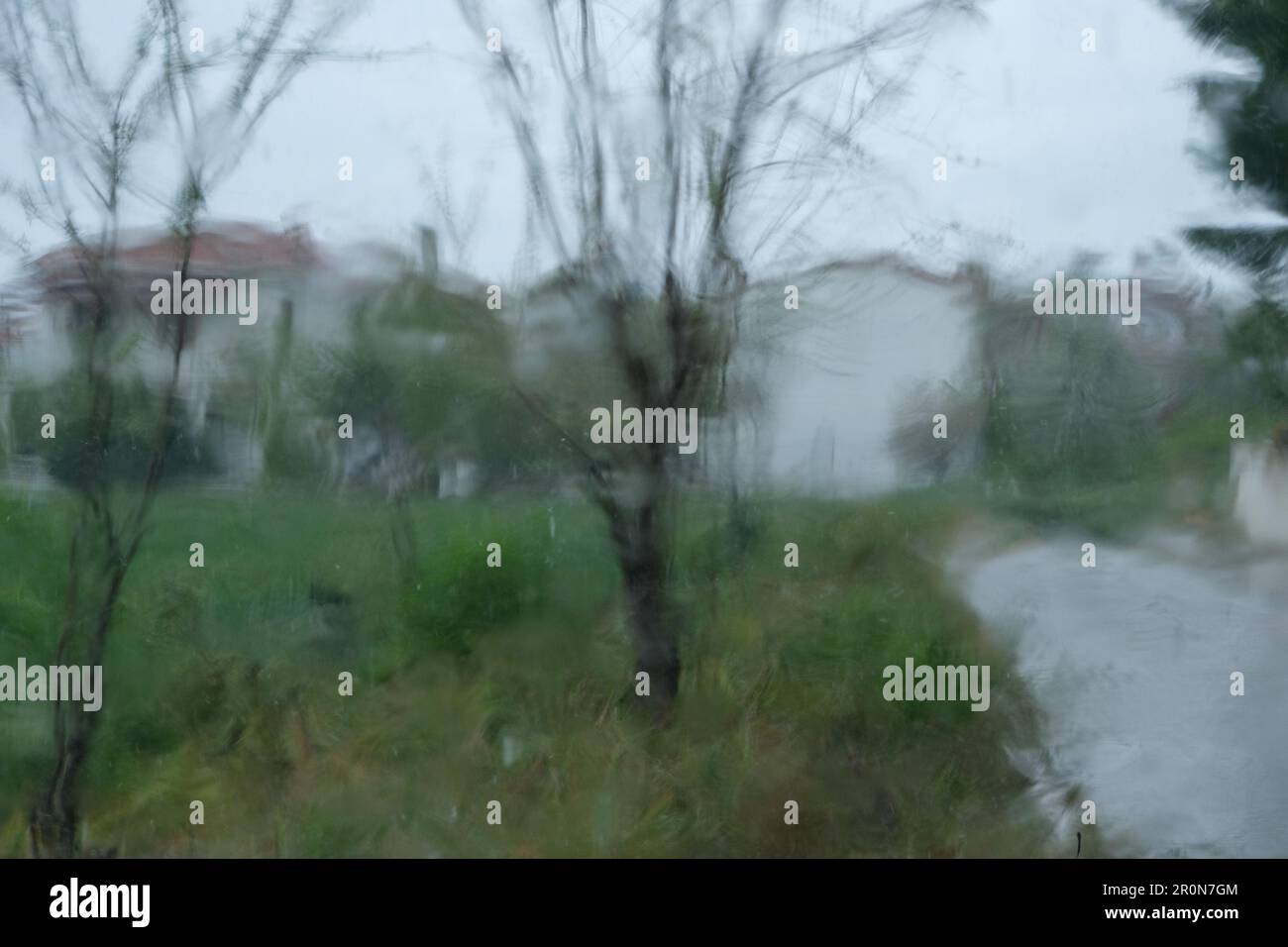 Wet window surface view from inside of car or house. Sad lonely nobody ...