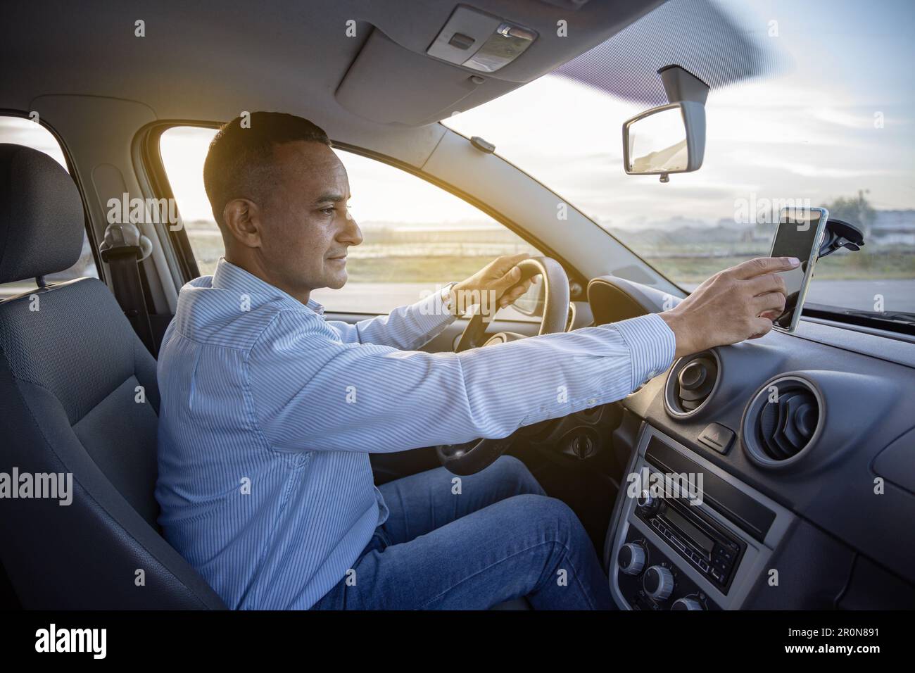 Driver using the GPS of his mobile phone inside his car Stock Photo - Alamy