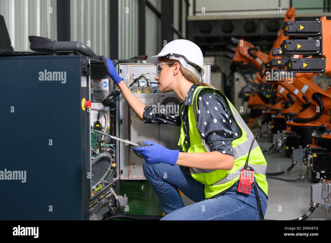 Female business owner engineer managing and checking work at factory ...