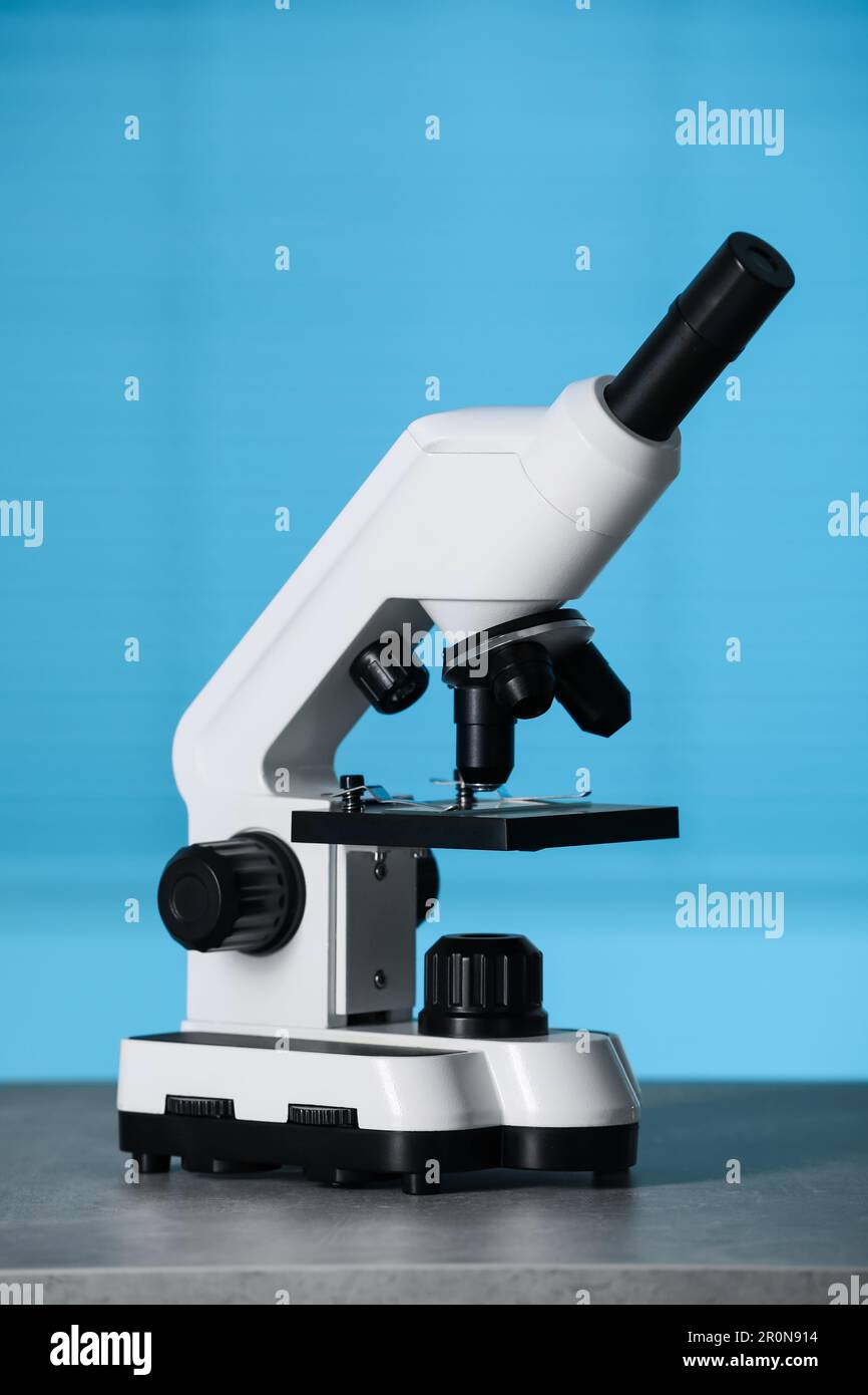 Modern medical microscope on grey table indoors Stock Photo - Alamy