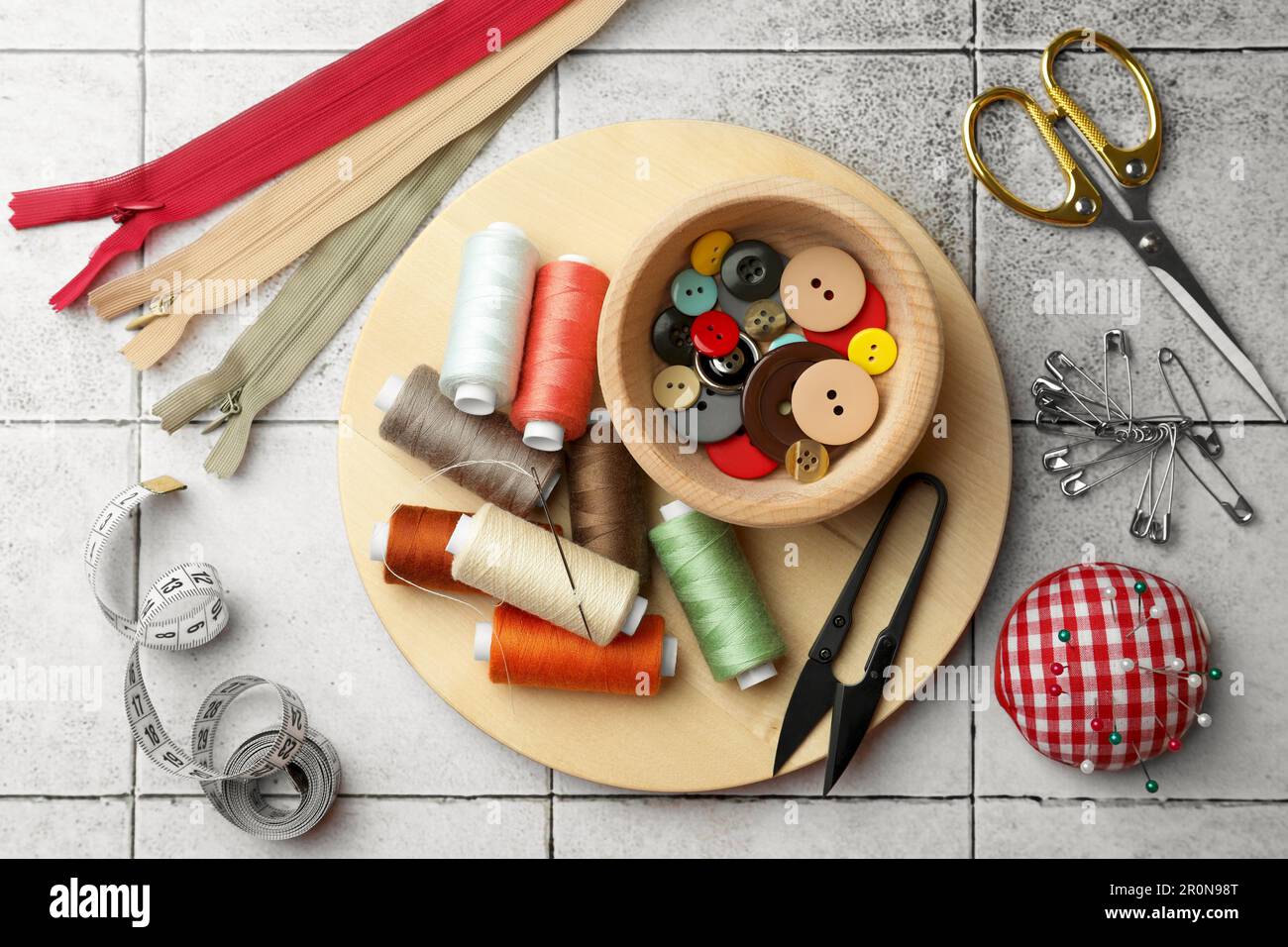 Flat lay composition with spools of threads and sewing tools on light ...