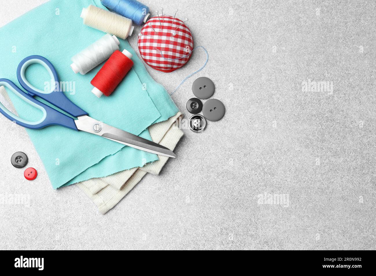 Flat lay composition with scissors, spools of threads and sewing tools ...