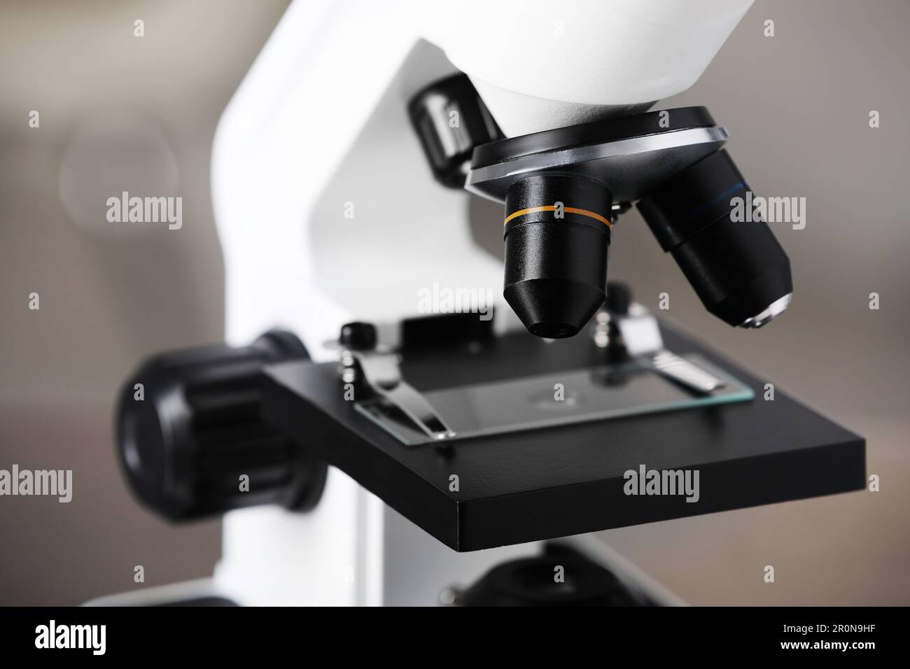 Modern medical microscope with glass slide on blurred background ...