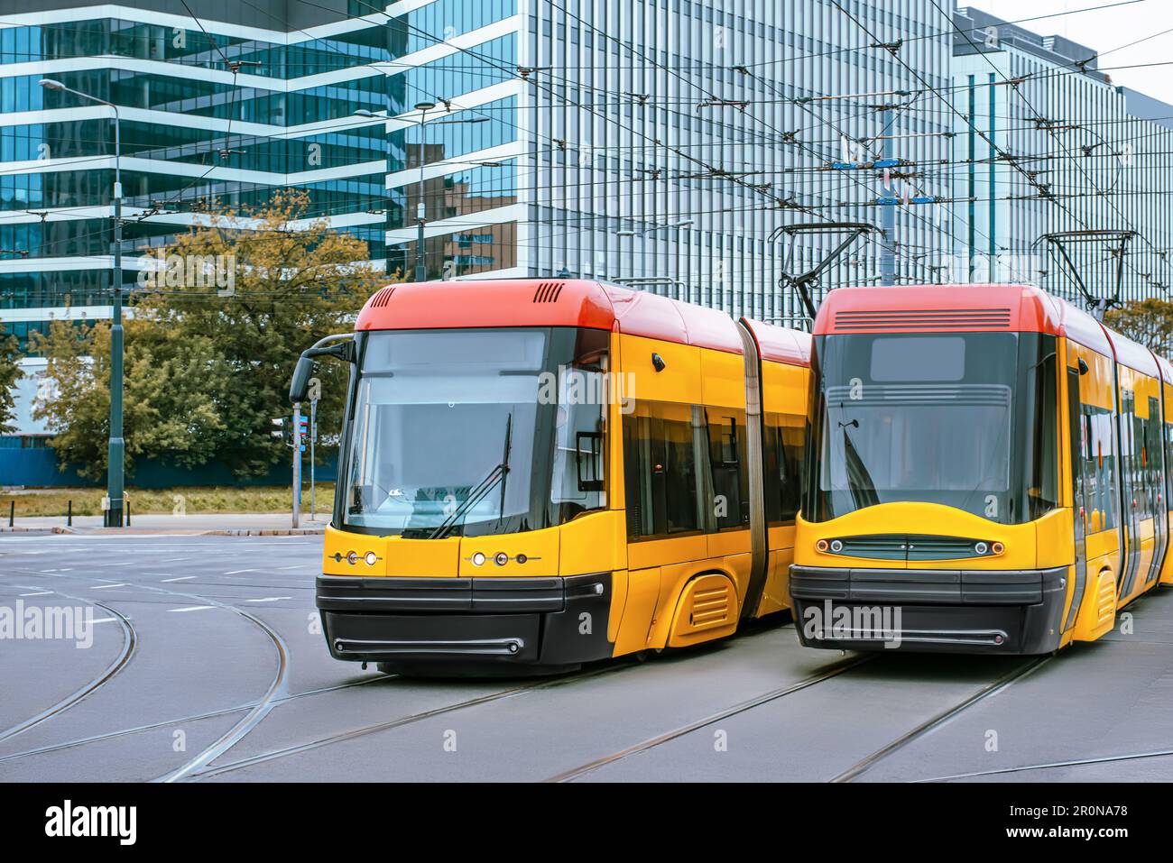 Modern trams on city street. Public transport Stock Photo - Alamy
