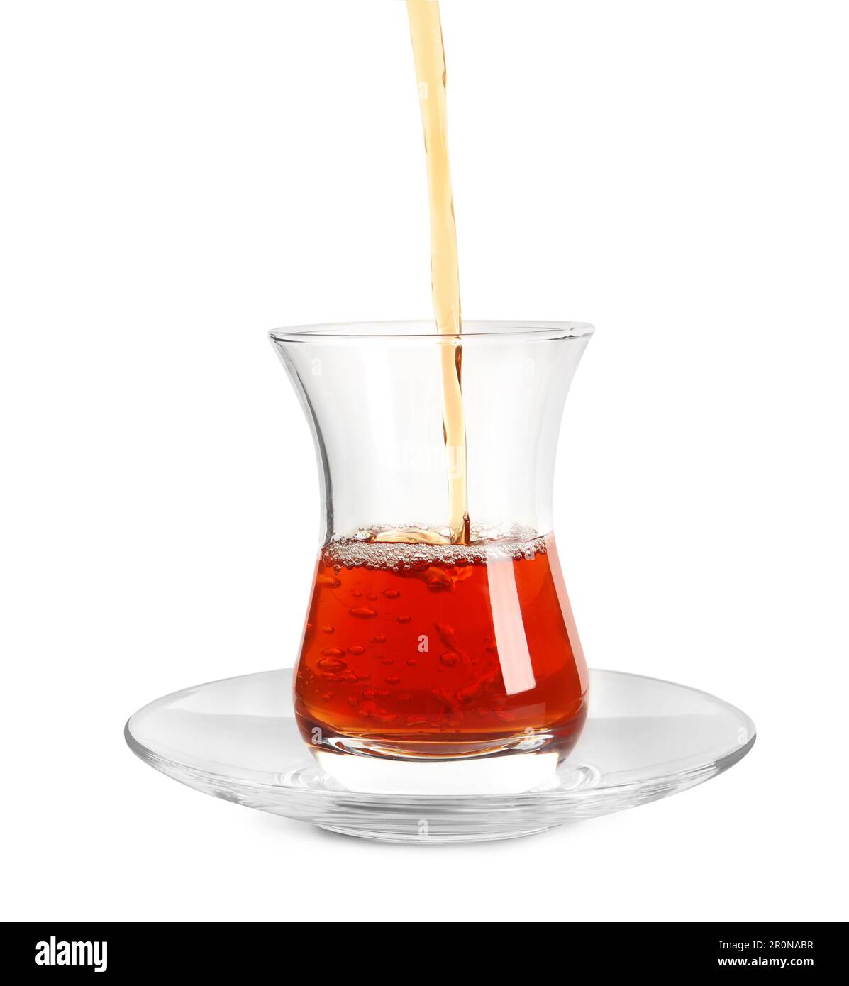 Pouring traditional Turkish tea into glass on white background Stock ...