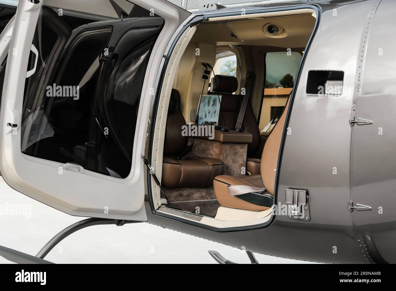 New helicopter with open cabin doors and leather seats Stock Photo - Alamy