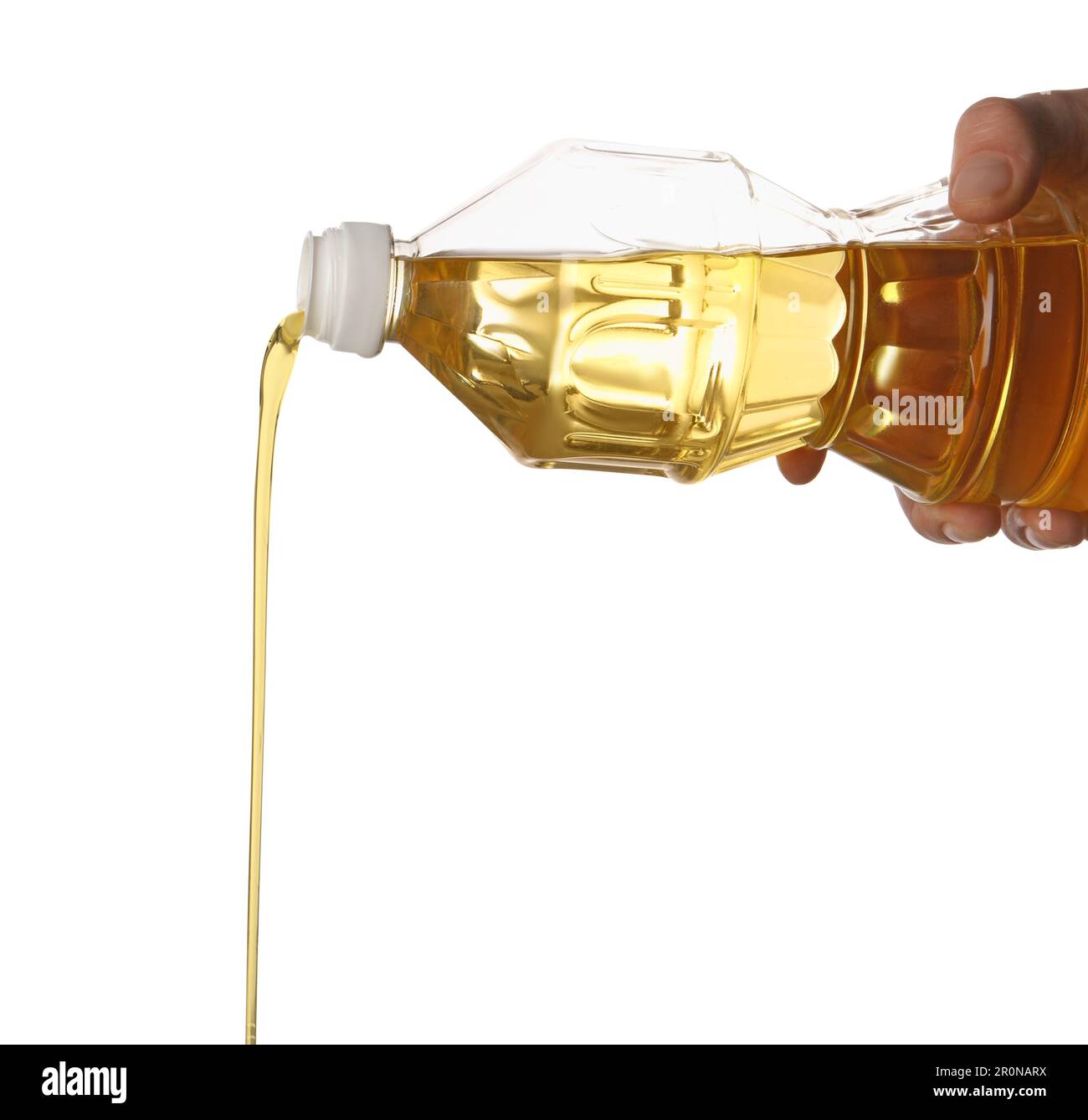 Pouring cooking oil from bottle on white background Stock Photo - Alamy