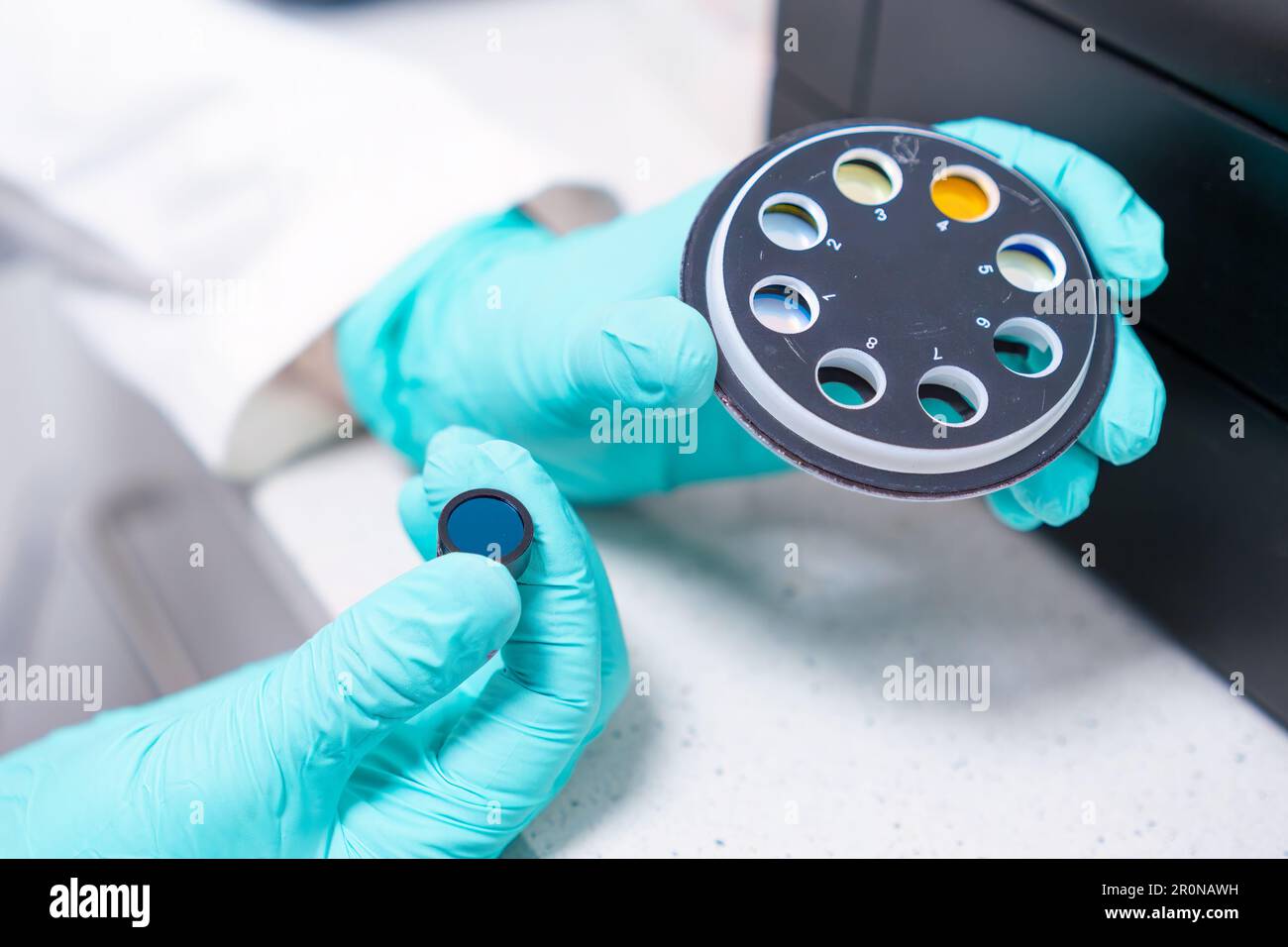 The scientist changes UV filters intended for microbiological analysis ...