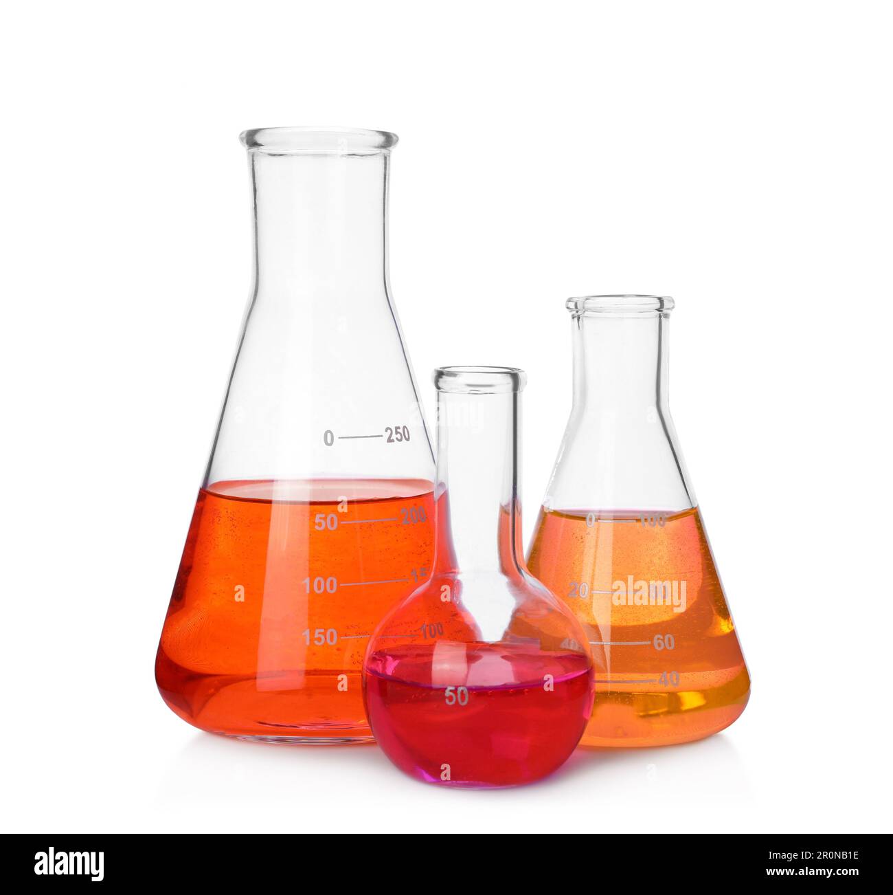 Different laboratory glassware with colorful liquids on white ...