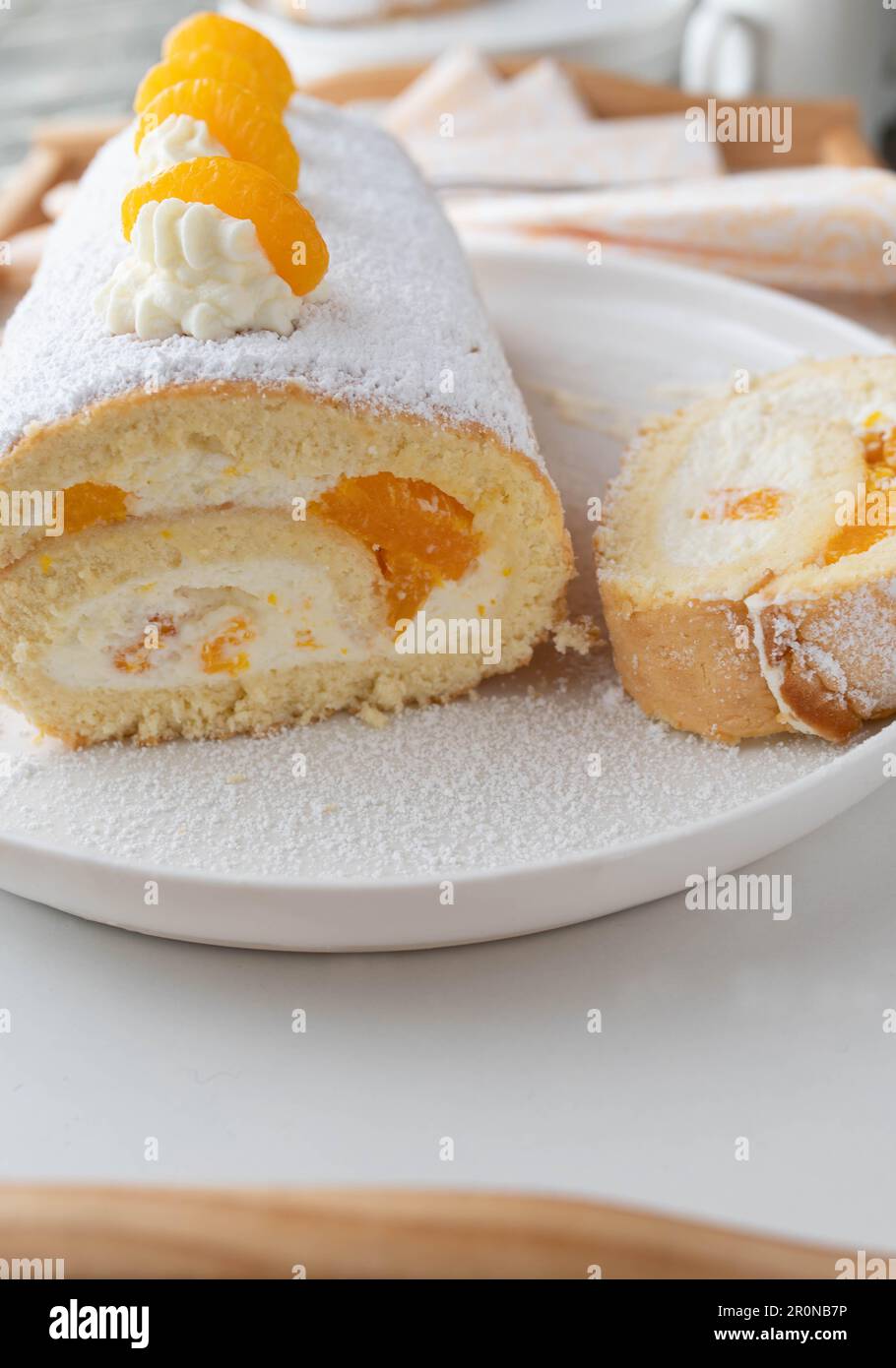 Swiss roll cake with mandarin orange filling on a platter Stock Photo ...