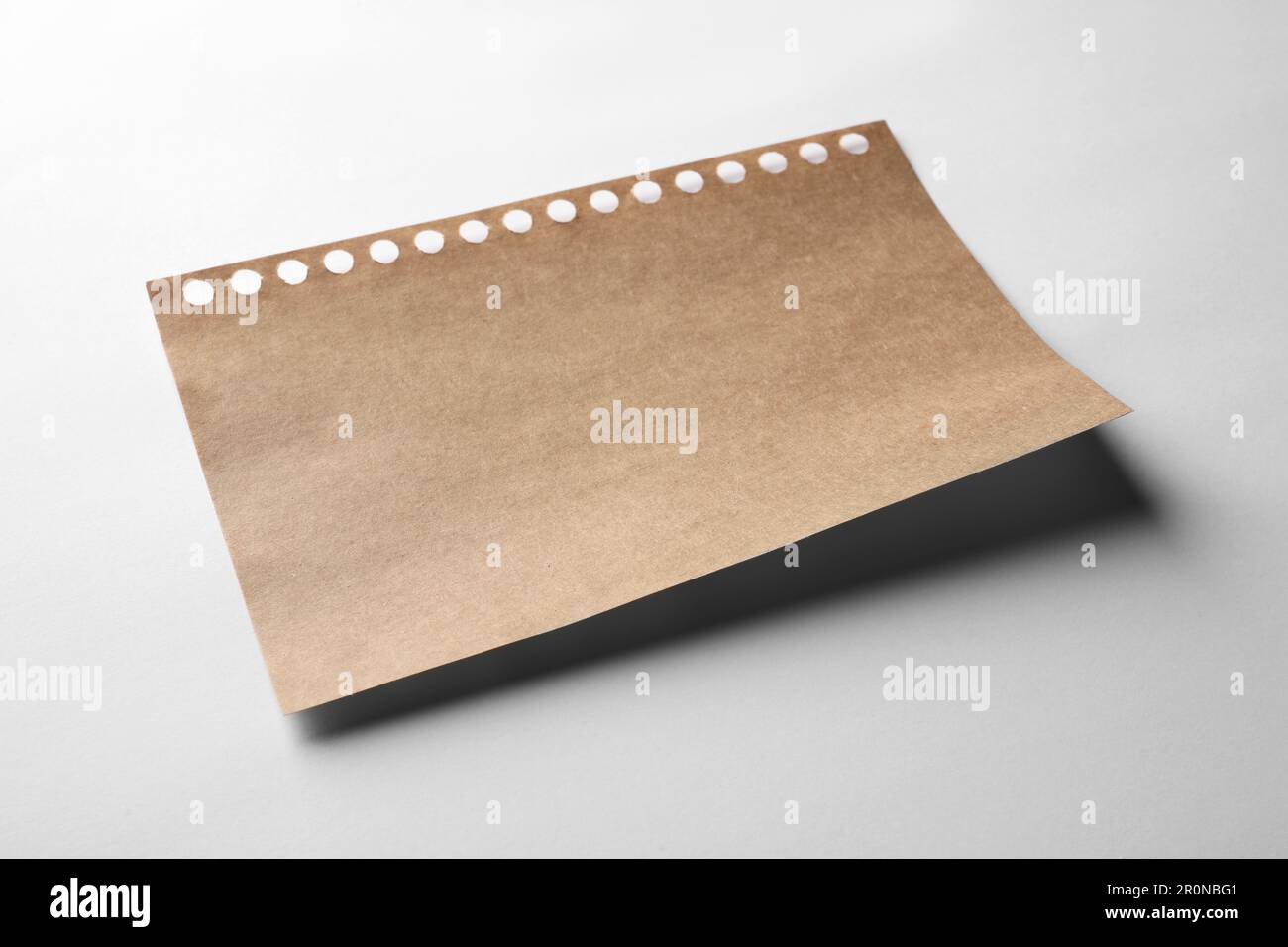 Brown sheet of paper on white background Stock Photo - Alamy