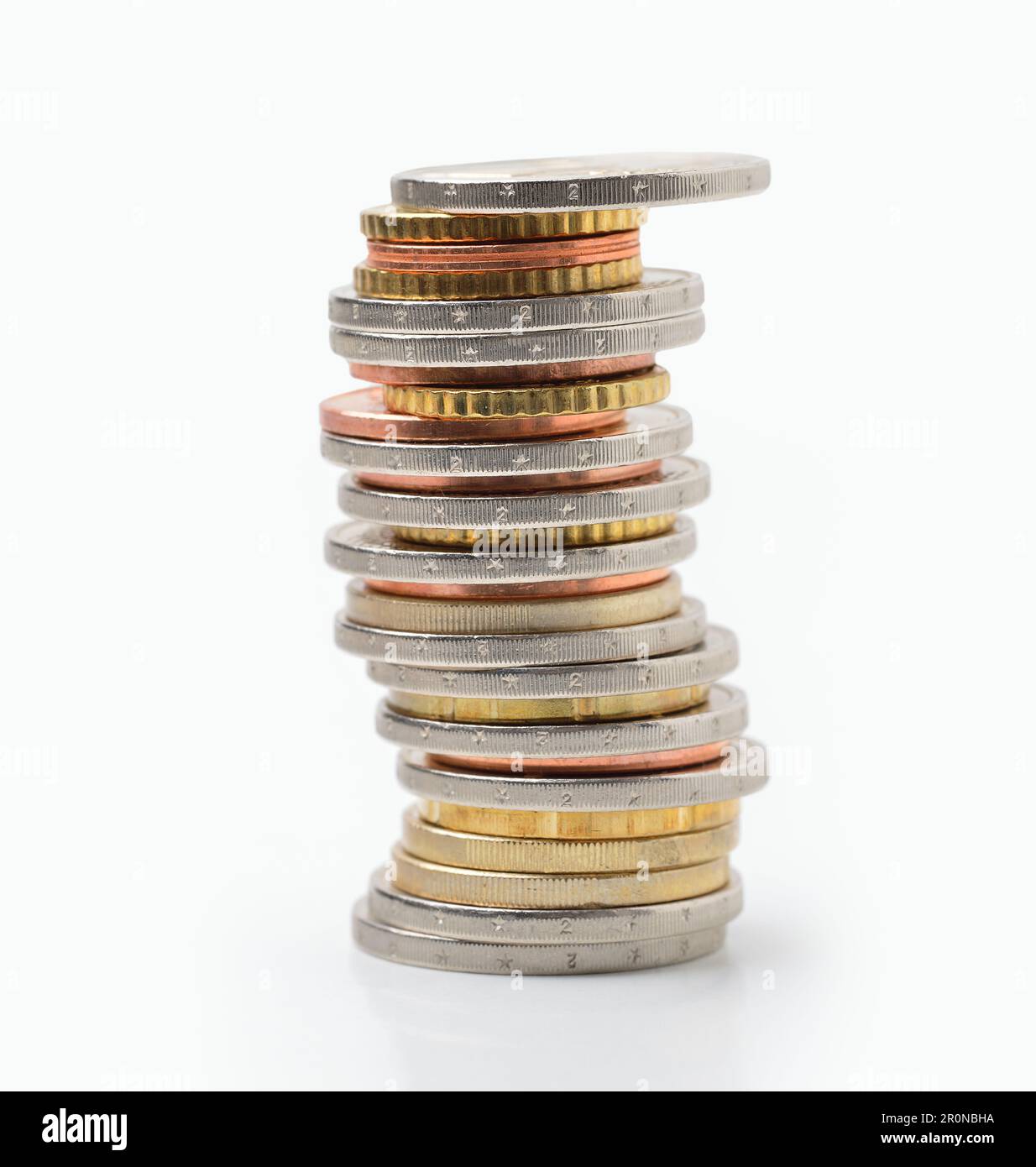Many coins in column isolated on white Stock Photo - Alamy