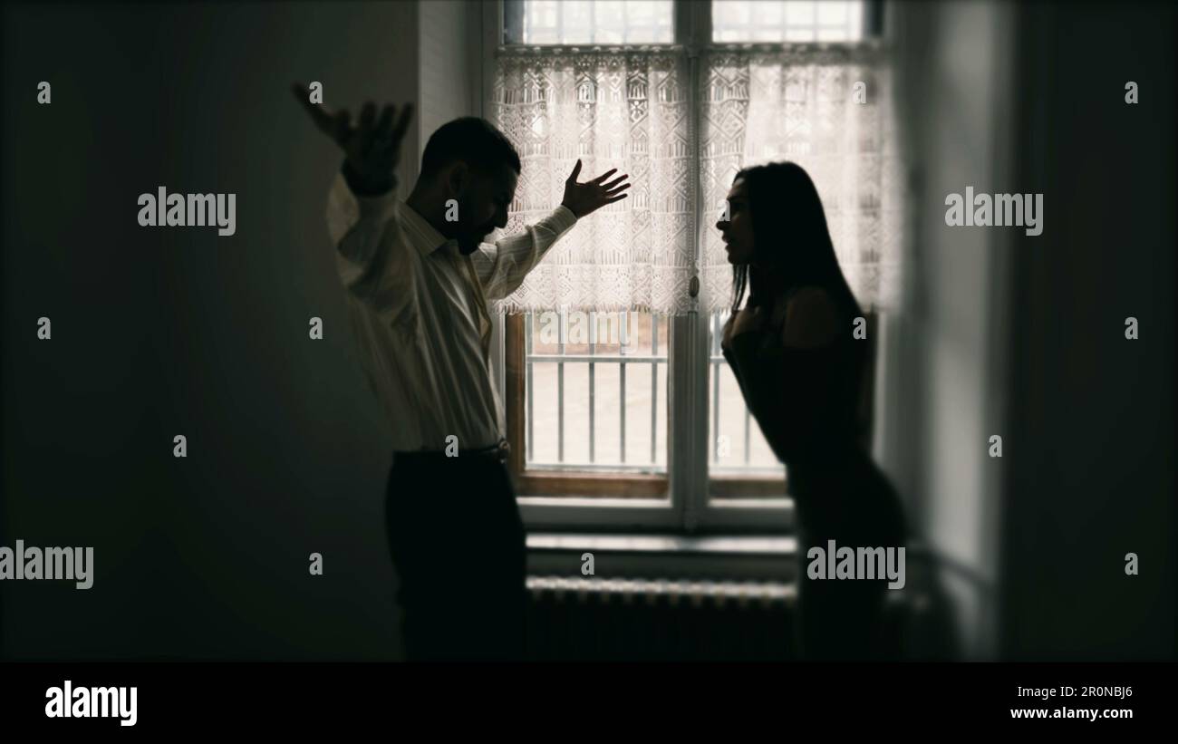 Silhouette of couple fighting each other, arguing and yelling at one ...
