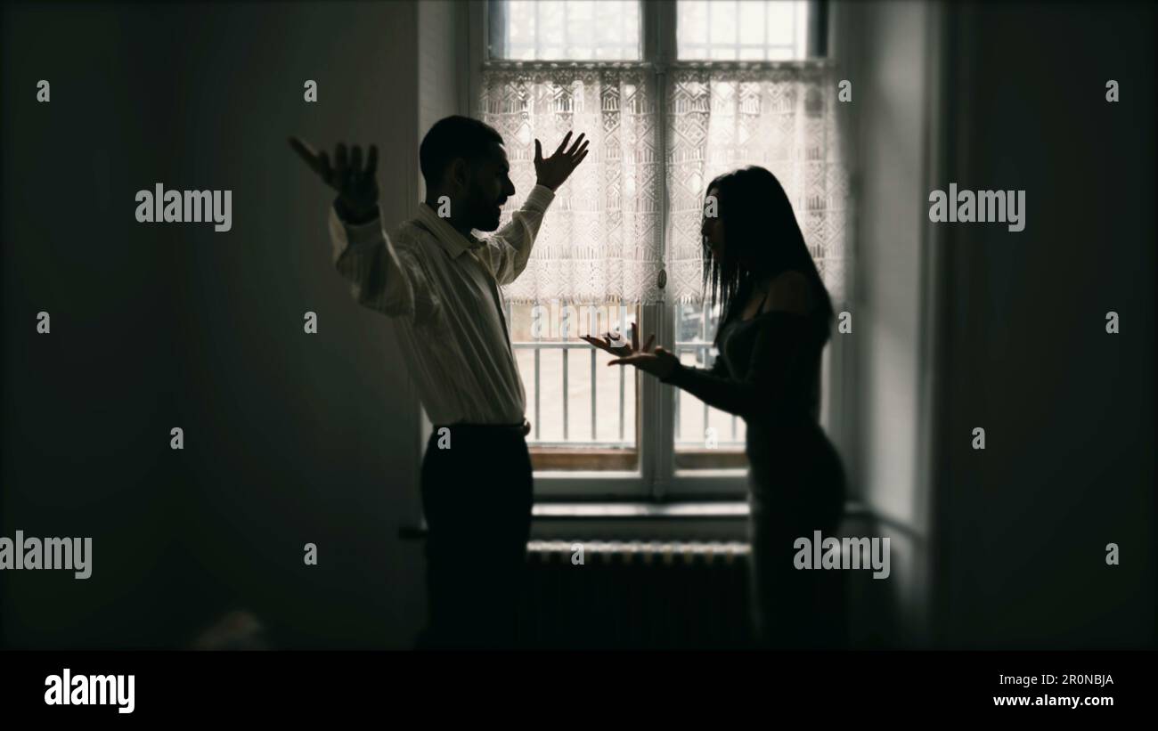Silhouette of couple fighting each other, arguing and yelling at one ...