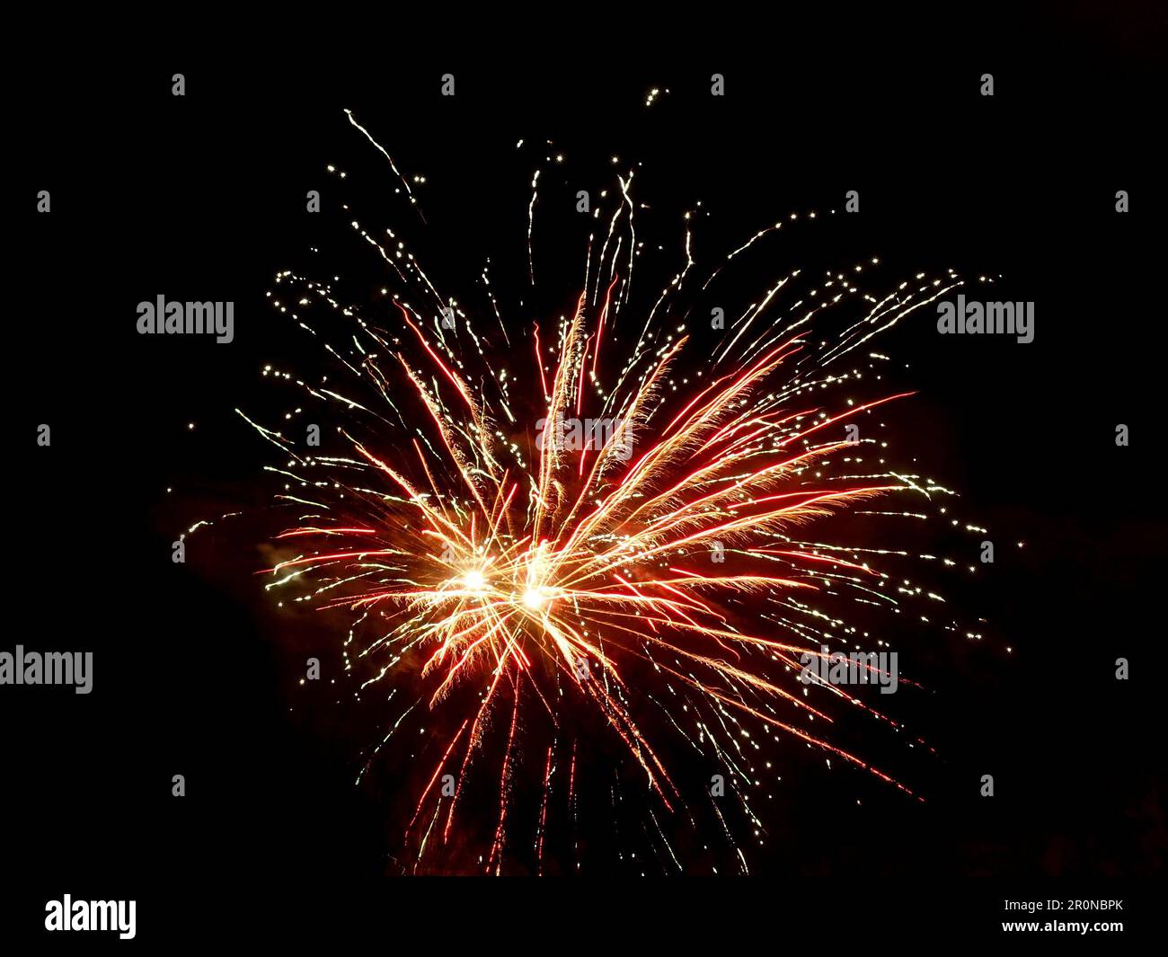 A bright firework explosion in the dark night sky Stock Photo - Alamy