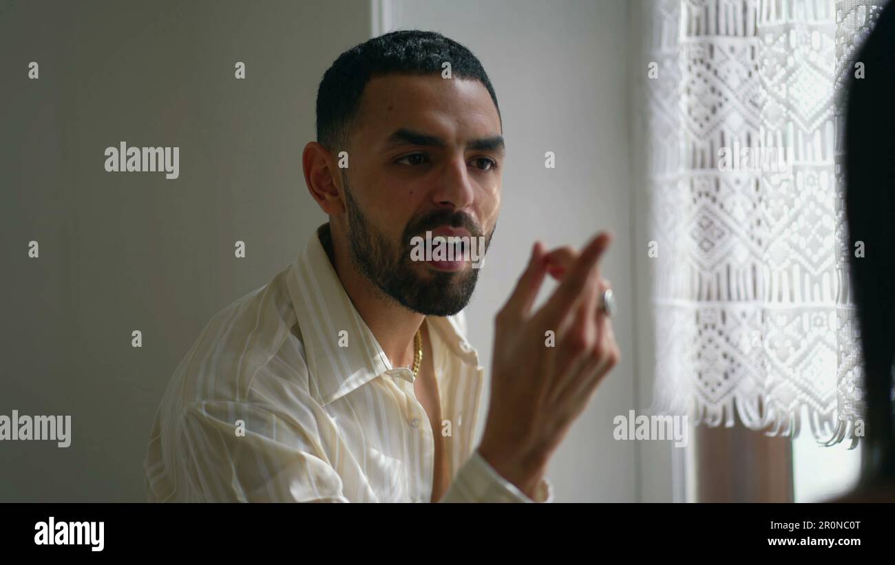 man discussing relationship with girlfriend off camera. Dramatic ...