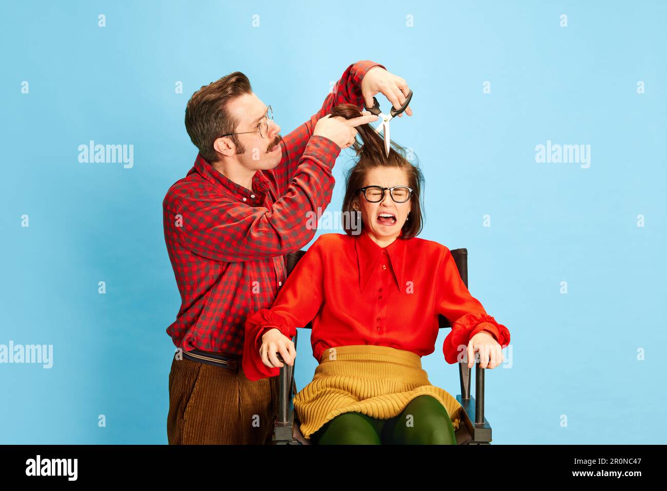 Portrait with shocked, screaming woman and crazy barber, hairdresser ...