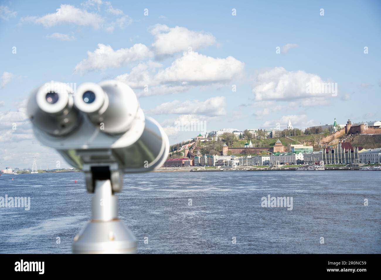 The telescope stands on the bank of River. The pipe is in focus, and ...