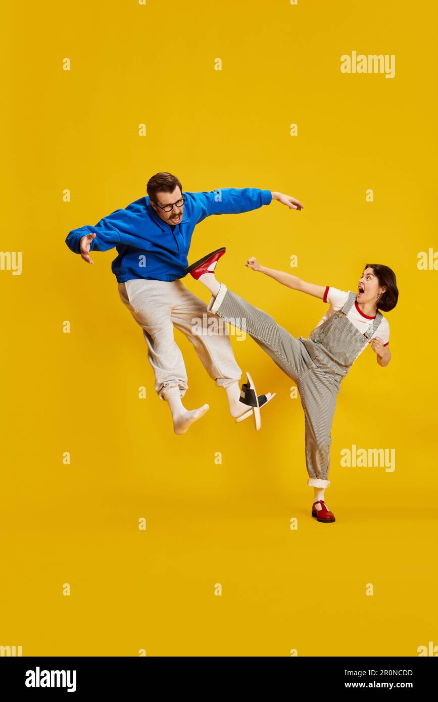 Portrait with funny couple, actors woman and man playing out a fight on ...