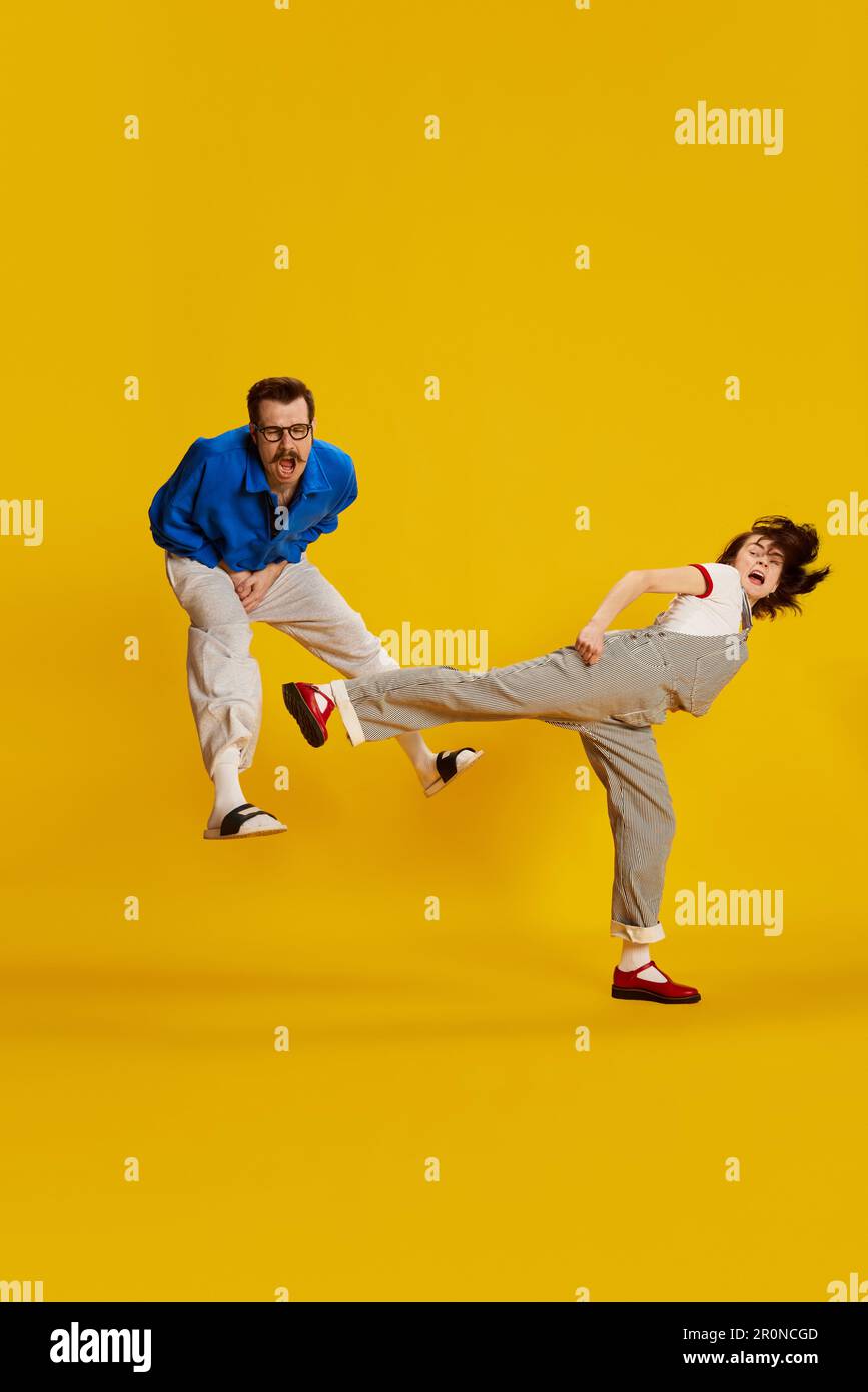 Portrait with funny couple, actors woman and man playing out a fight on ...