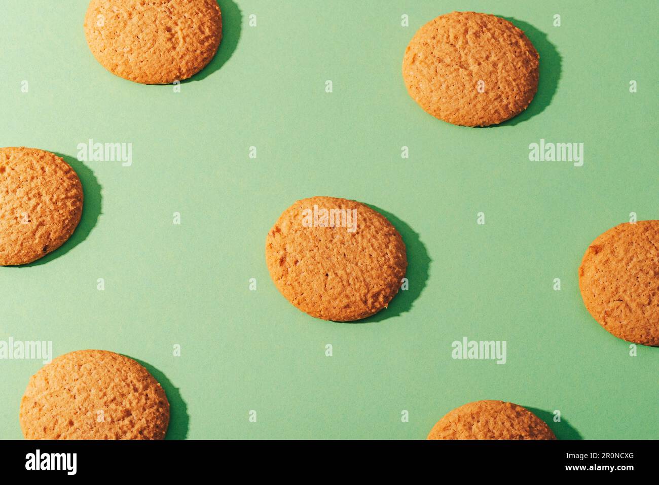Homemade cookies on green background with sharp shadows. Top view, flat ...
