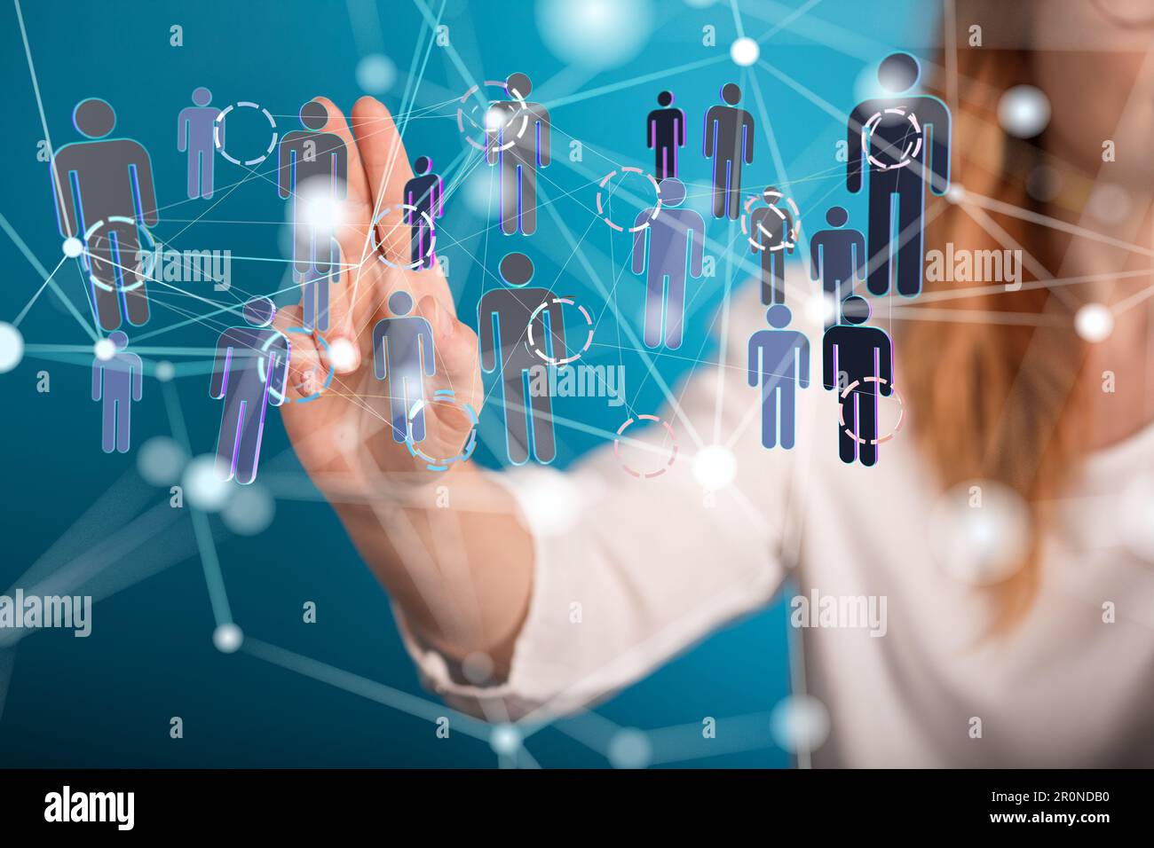 A businesswoman clicking on virtually interconnected people icons Stock ...