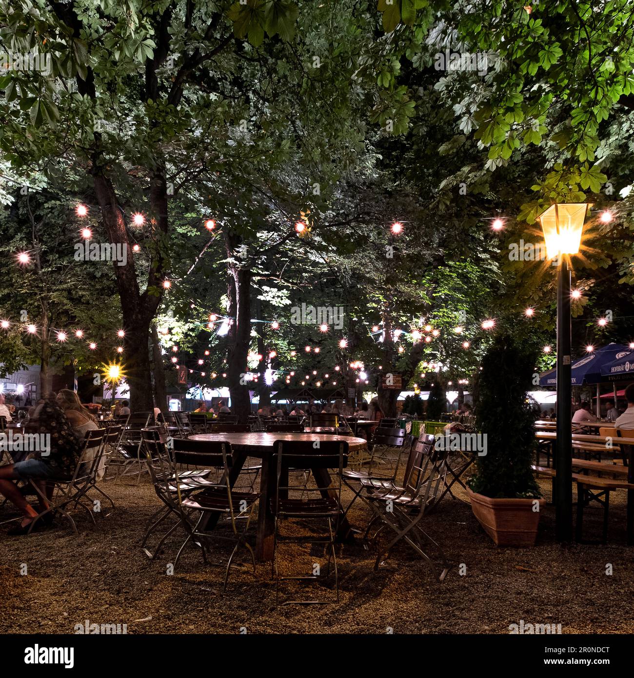 View of the beer garden at Wiener Platz at night, Munich, Bavaria ...