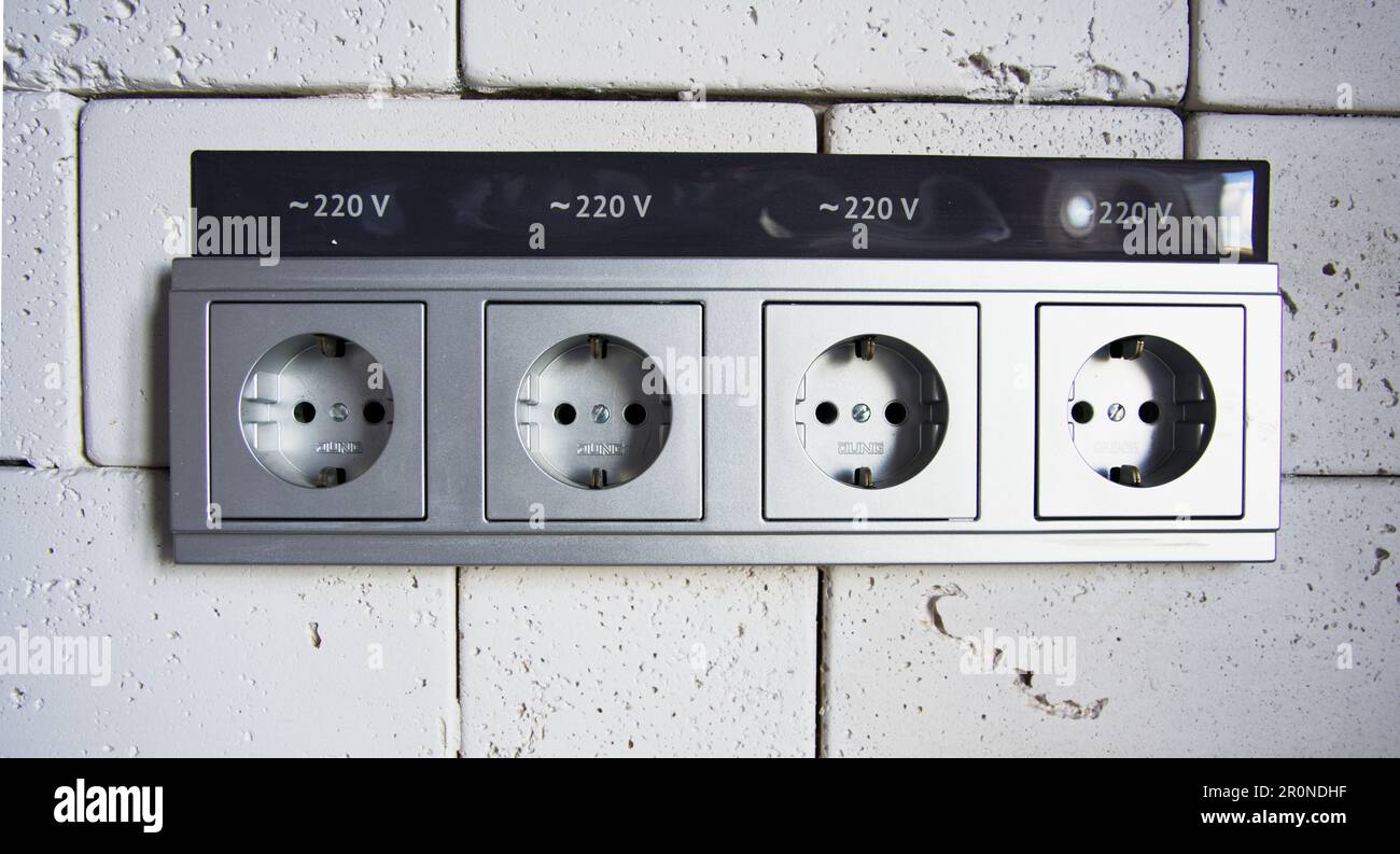 A gray electrical outlet unit built into the wall Stock Photo - Alamy