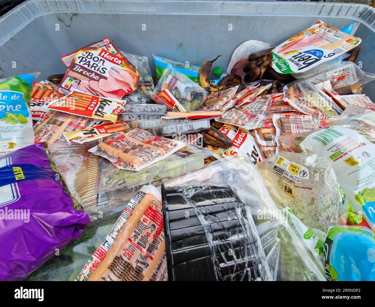 Expired foods in a garbage dumpster, Lyon, France Stock Photo - Alamy