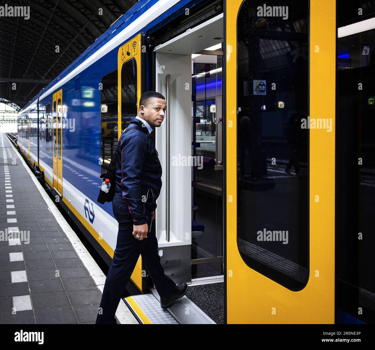 AMSTERDAM - A conductor of the new Sprinter at Amsterdam Central. A ...