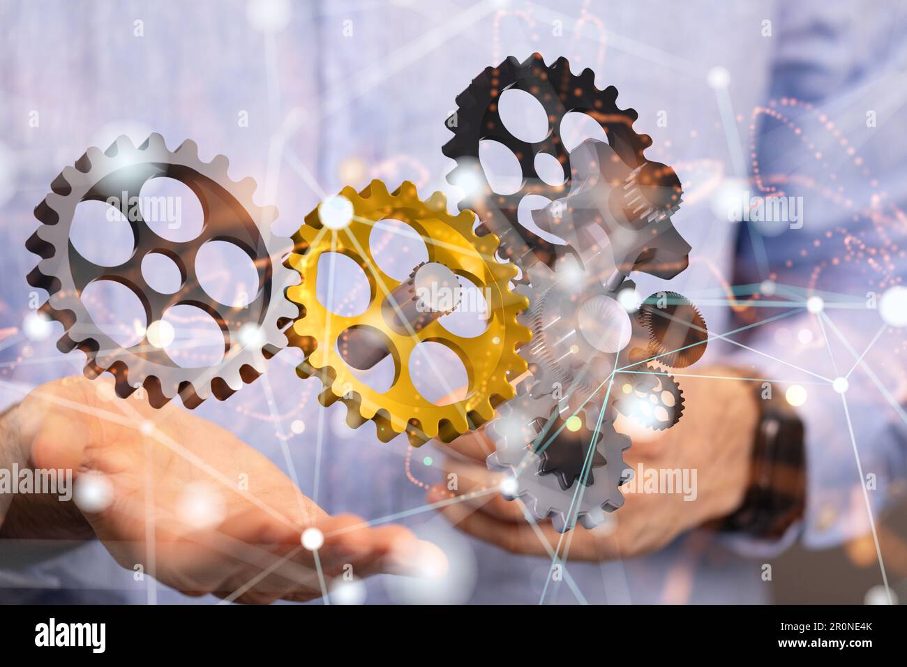 A person holding gear wheels in the palm of their hands Stock Photo - Alamy