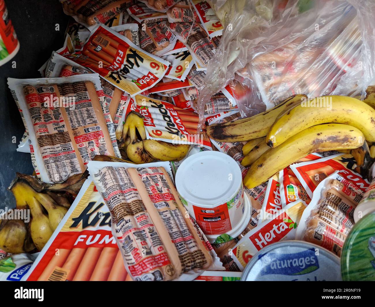 Expired foods in a garbage dumpster, Lyon, France Stock Photo - Alamy
