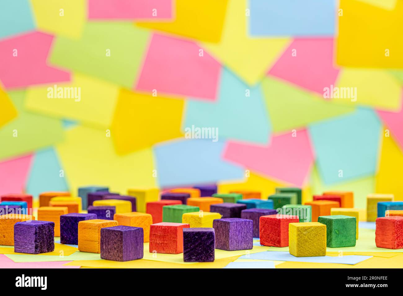 Colorful wood block with a background of multicolored paper sticky ...