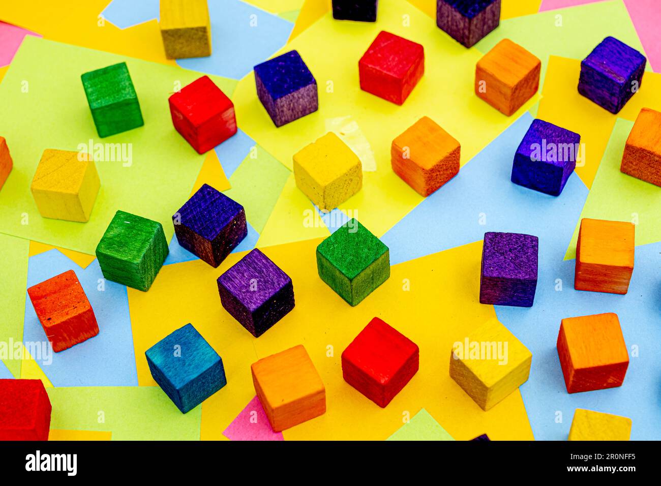 Colorful wood block with a background of multicolored paper sticky ...