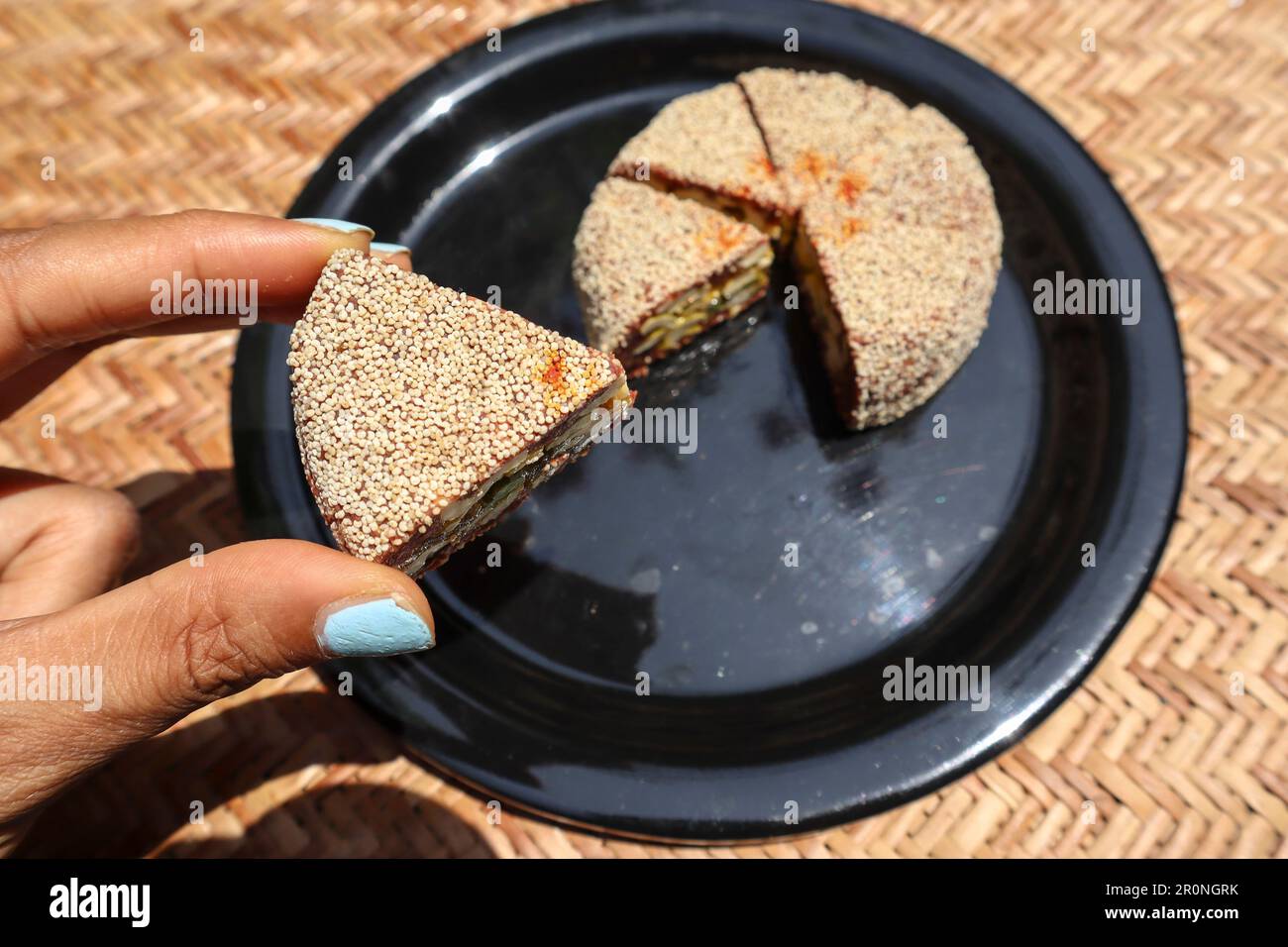 Female holding Slices of Anjeer cake, Indian sweet dish item covered ...