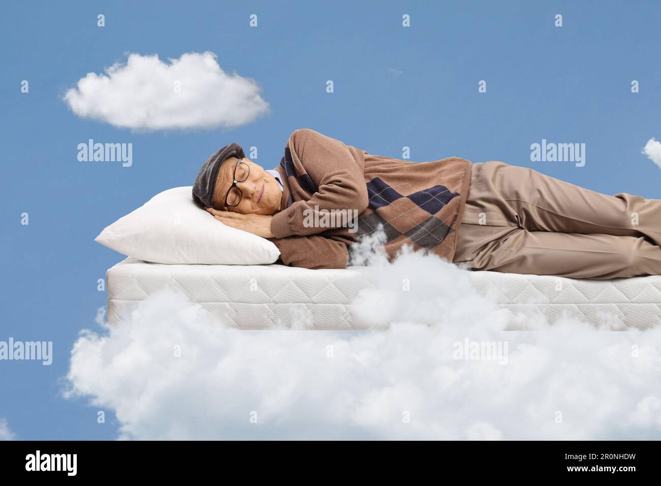 Elderly man sleeping on a matress and floating on clouds Stock Photo ...
