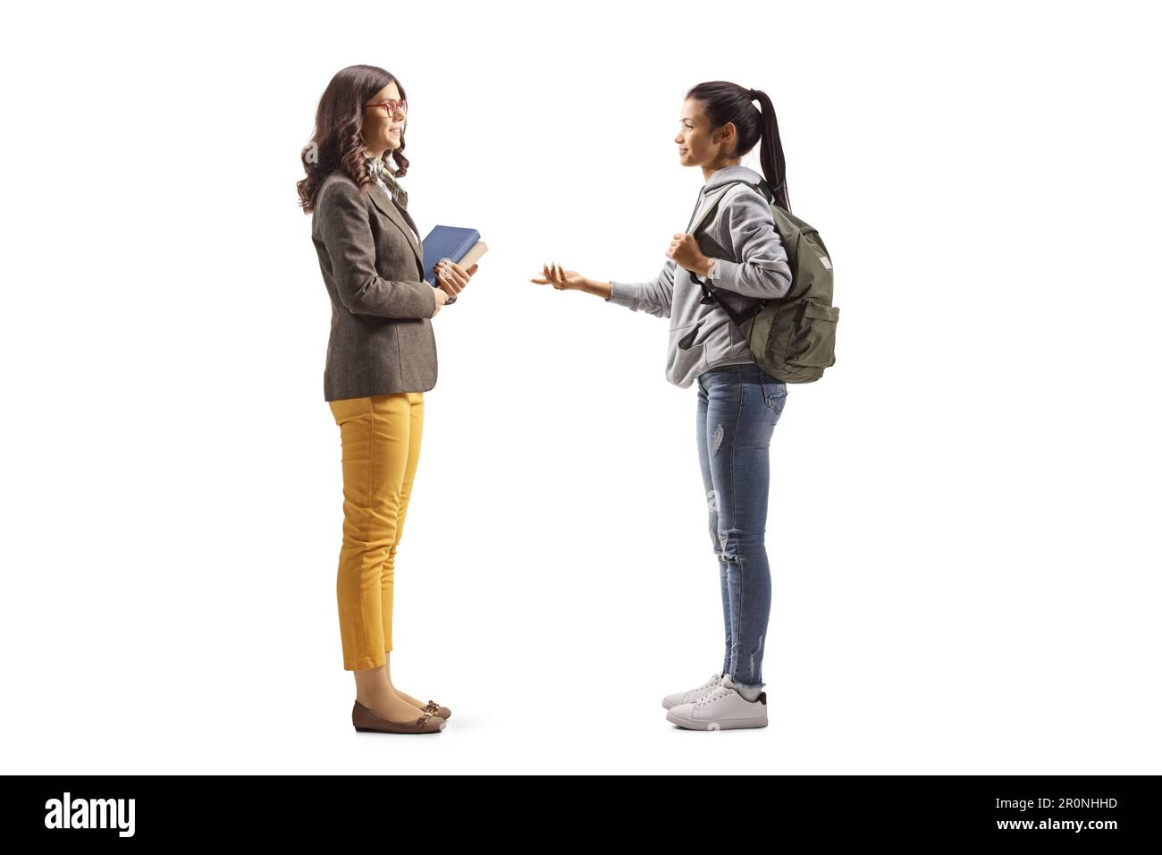 Full length profile shot of a female student talking to a young woman ...