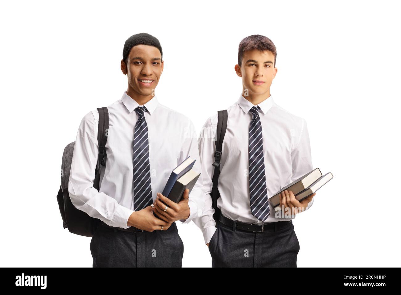 Male students in school uniforms holding books isolated on white ...
