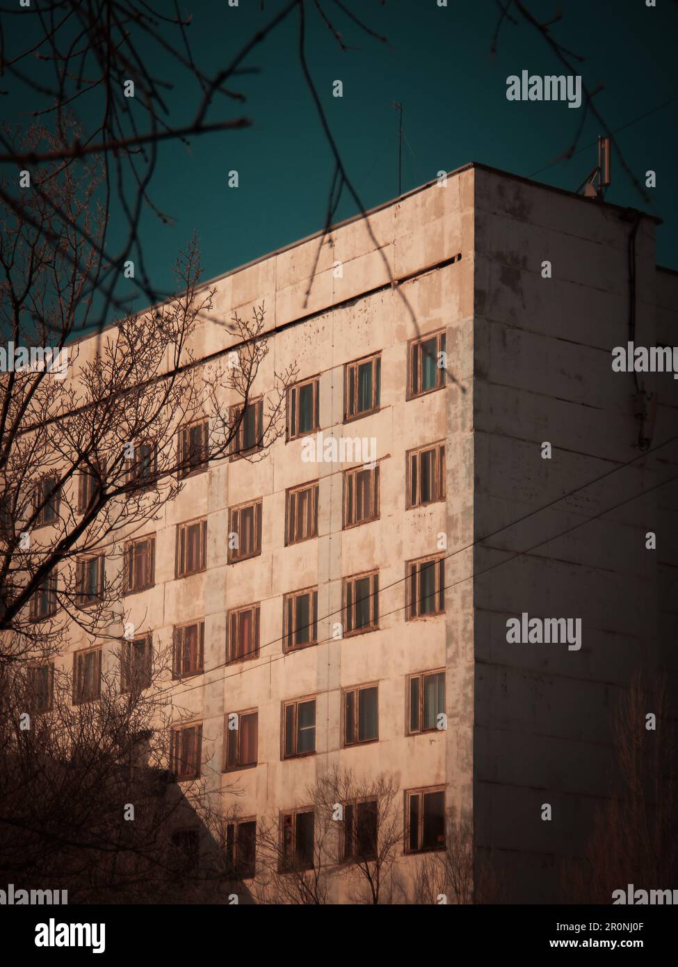 Exterior side view of a building illuminated by the sun, contrasting ...