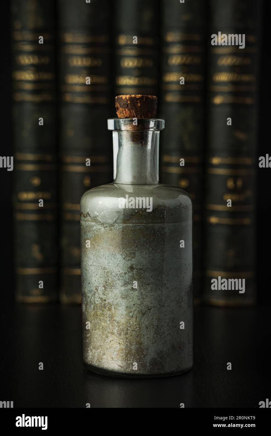 Mercury (hg 80) 1800s bottle of 1kg isolated with old book background ...