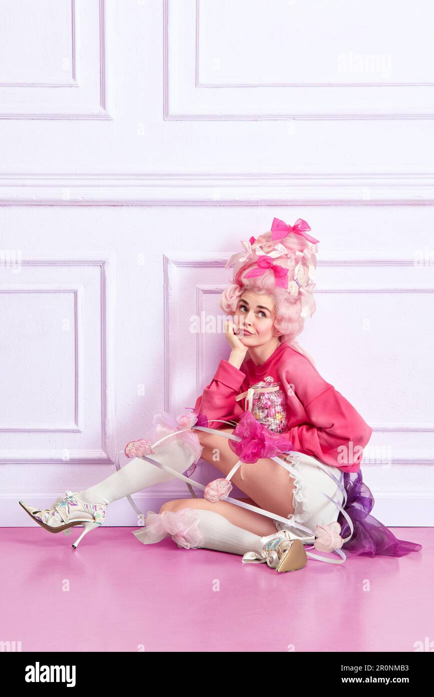 Portrait of young girl, sad princess wearing elegant pink clothes, and ...