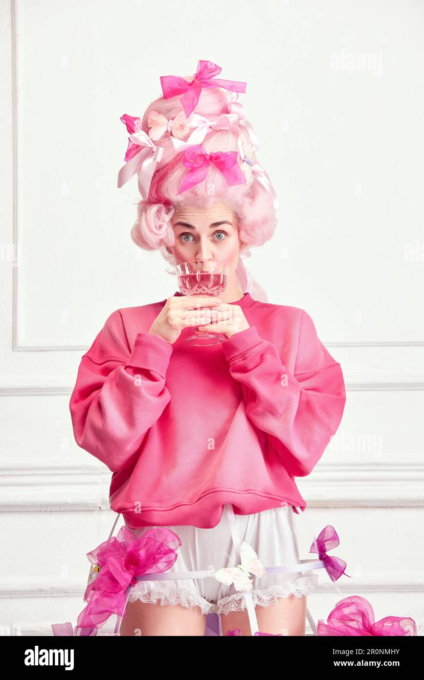 Portrait of young princess, queen wearing elegant pink clothes, and wig ...