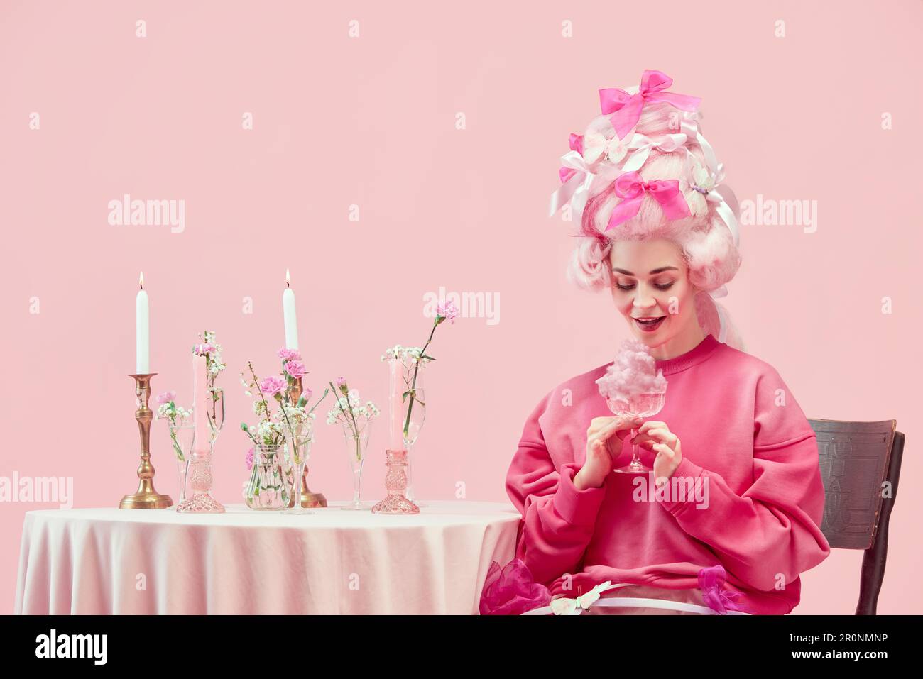 Portrait with fairy tail young princess wearing big pink wig holding ...