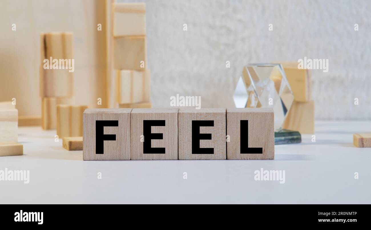 The word 'FEEL' written on wood cube Stock Photo - Alamy