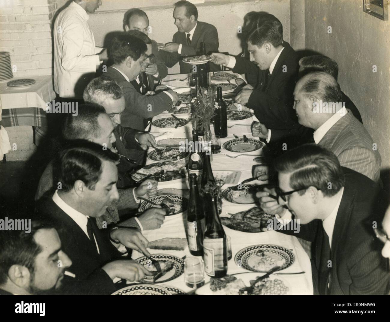 Large group of men having dinner at a restaurant, Italy 1960s Stock ...