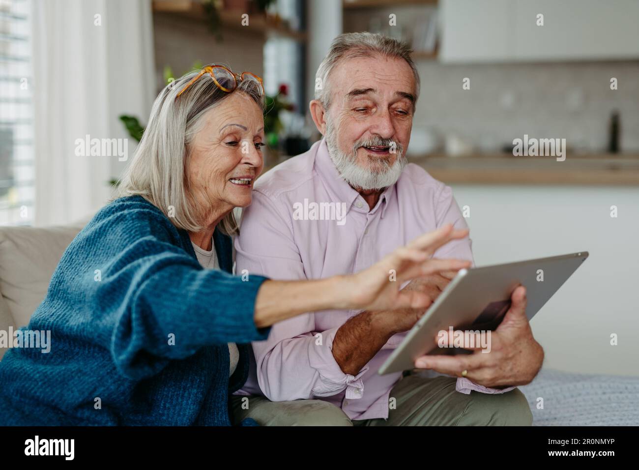 Senior woman scrolling online indoors hi-res stock photography and ...