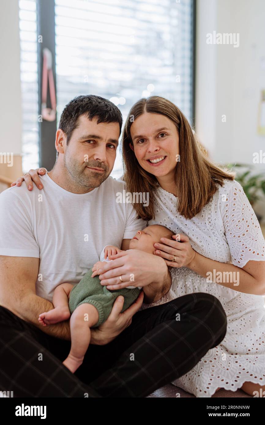 Happy parents cuddling with their newborn baby Stock Photo - Alamy